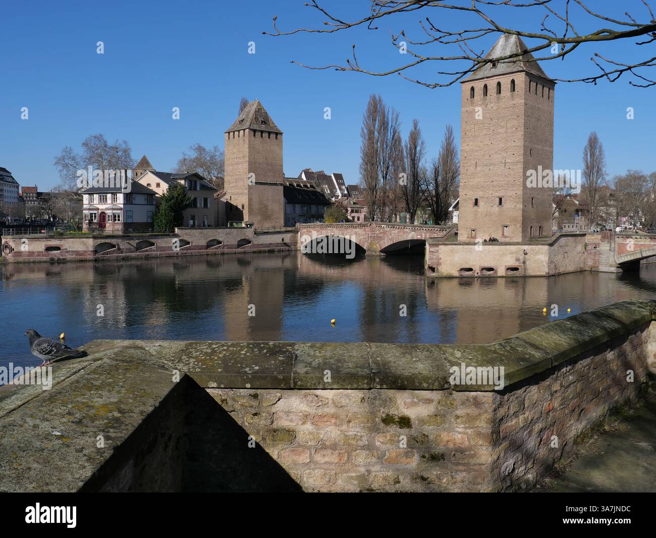 The covered bridges in Strasbourg with historic towers and islands on ...