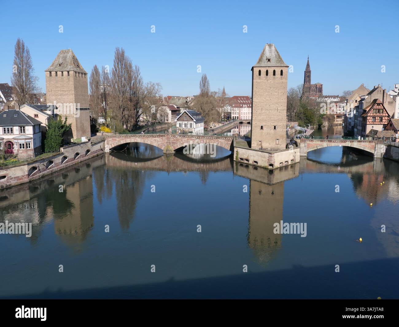 The covered bridges in Strasbourg with historic towers and islands on ...