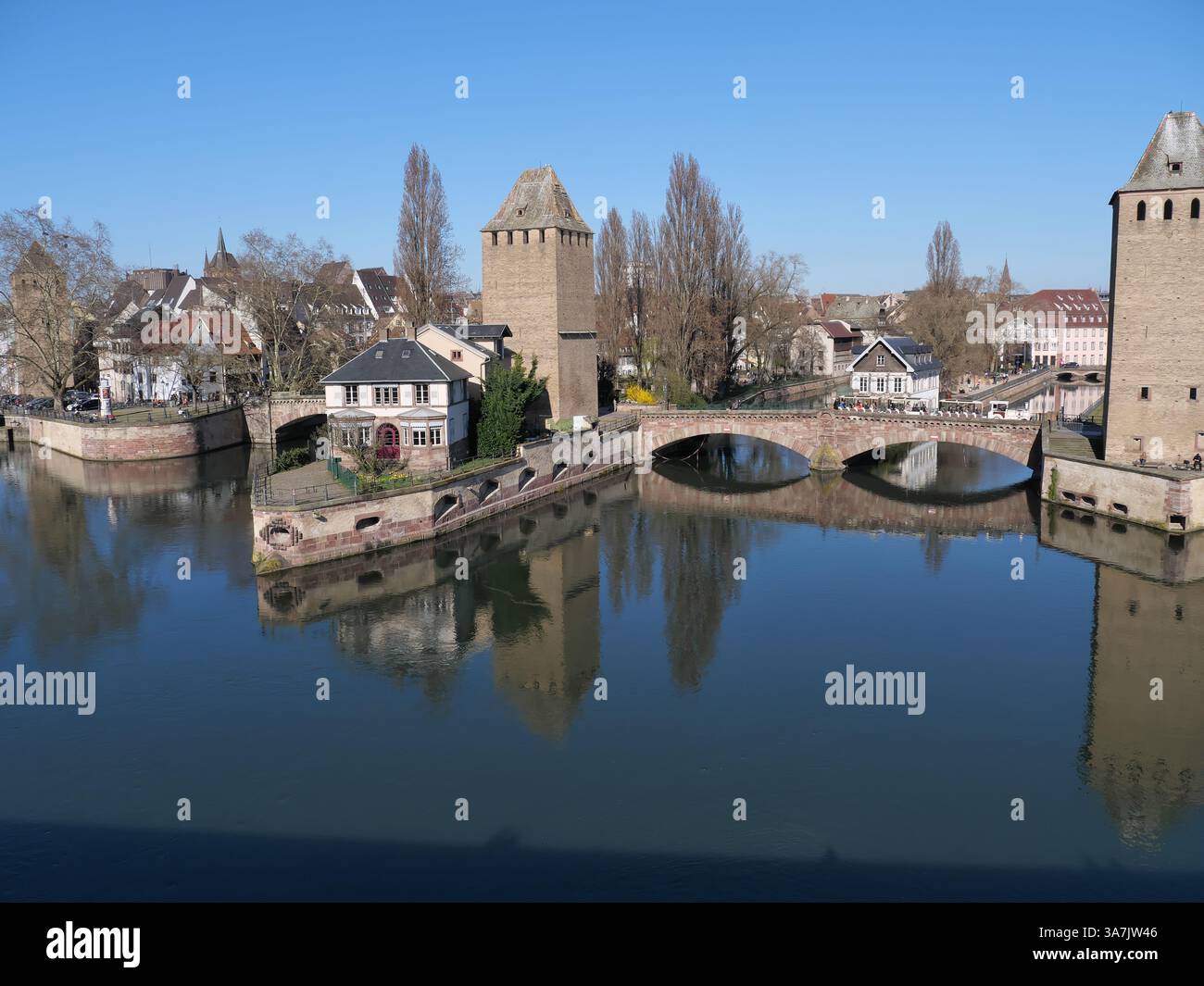 The covered bridges in Strasbourg with historic towers and islands on ...