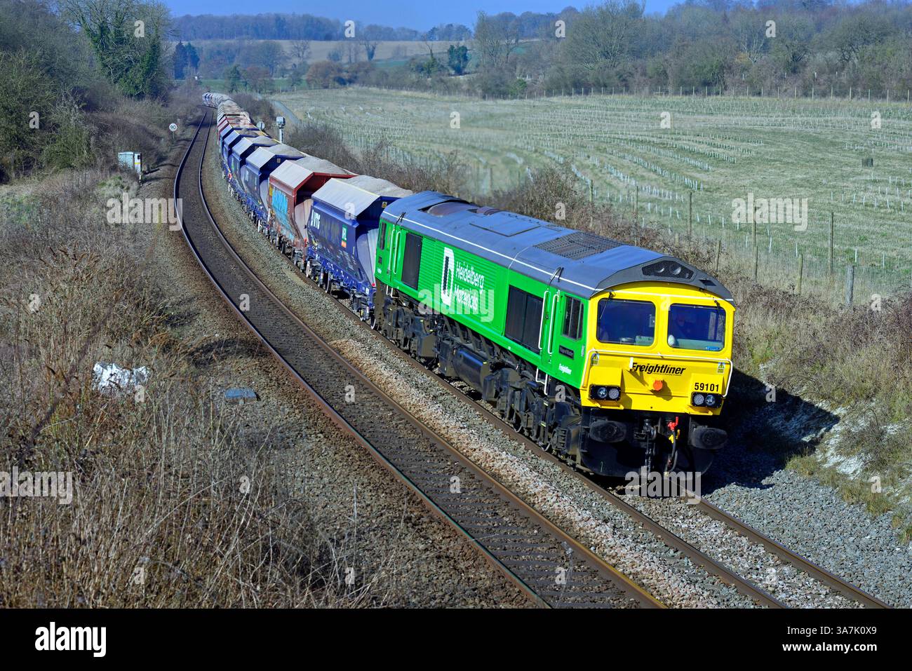 A loaded stone train descends from Savernake summit on the Berks & Hants line and is seen at ...