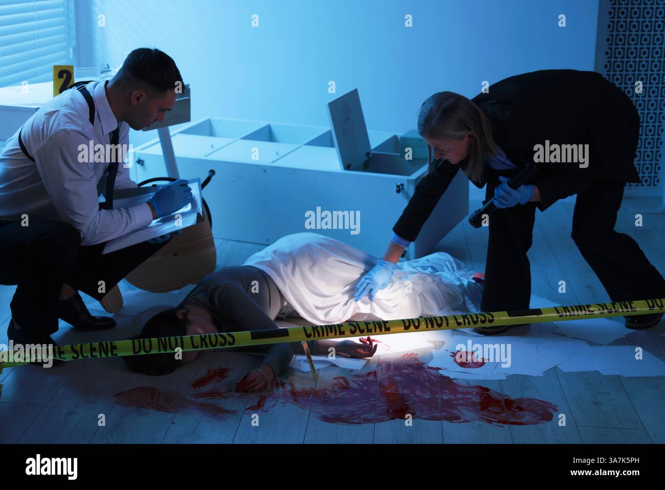 Forensic experts working at crime scene with dead woman's body indoors ...