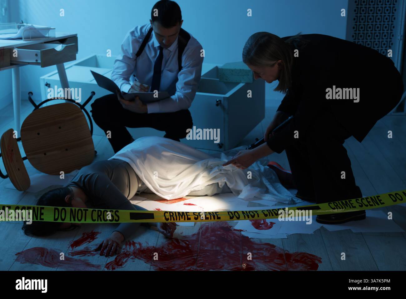 Forensic experts working at crime scene with dead woman's body indoors ...