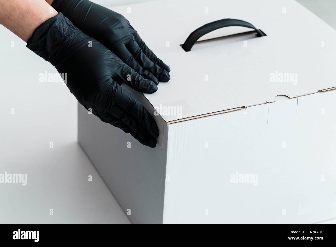 Gloved Hands Securing White Cardboard Box for Safe Delivery and ...