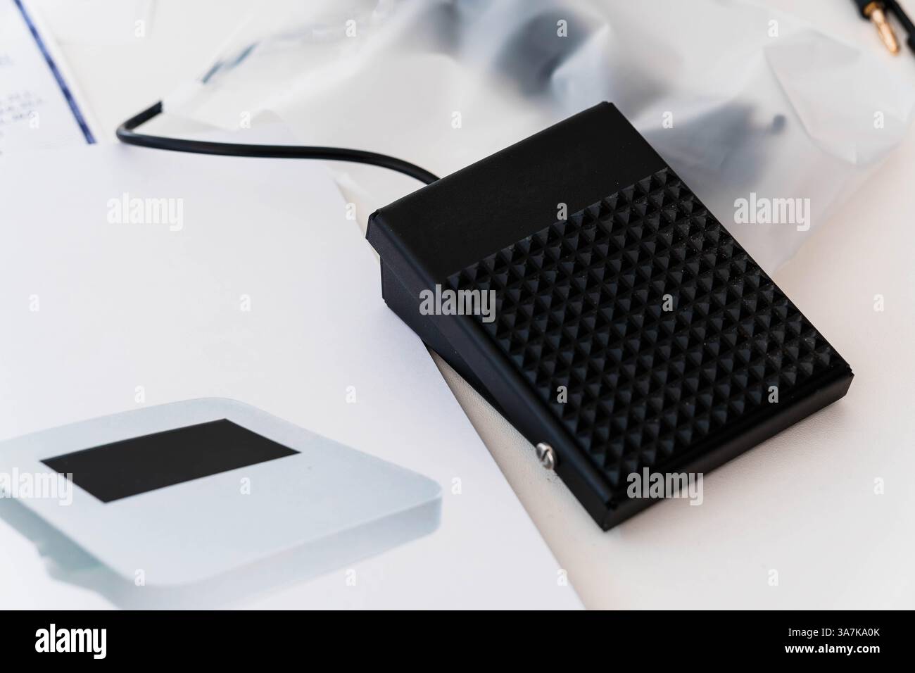 Close-Up View of Black Foot Pedal Switch on Desk with Electronic Device ...