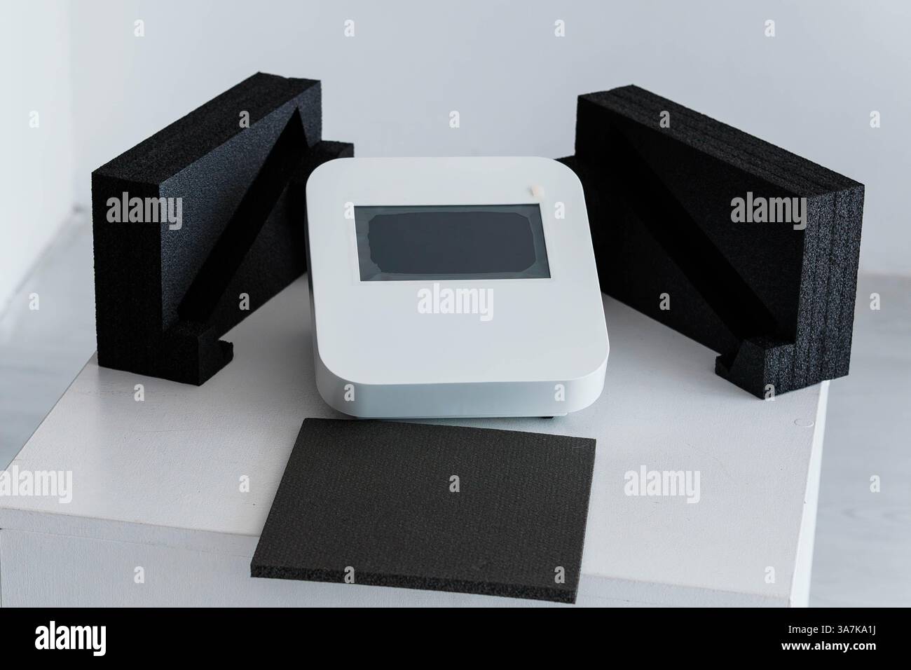 Modern White Electronic Device Displayed With Black Protective Foam ...