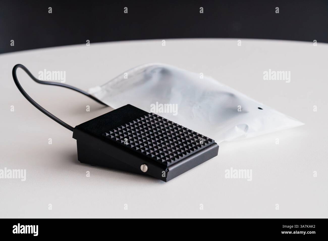 Black Foot Switch Pedal with Cable on White Surface Near Transparent ...