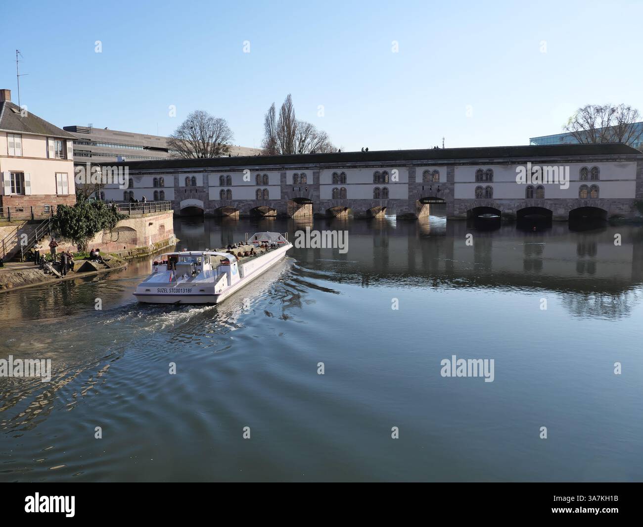 Boat on the river Ill in front of the Barrage Vauban and the ...