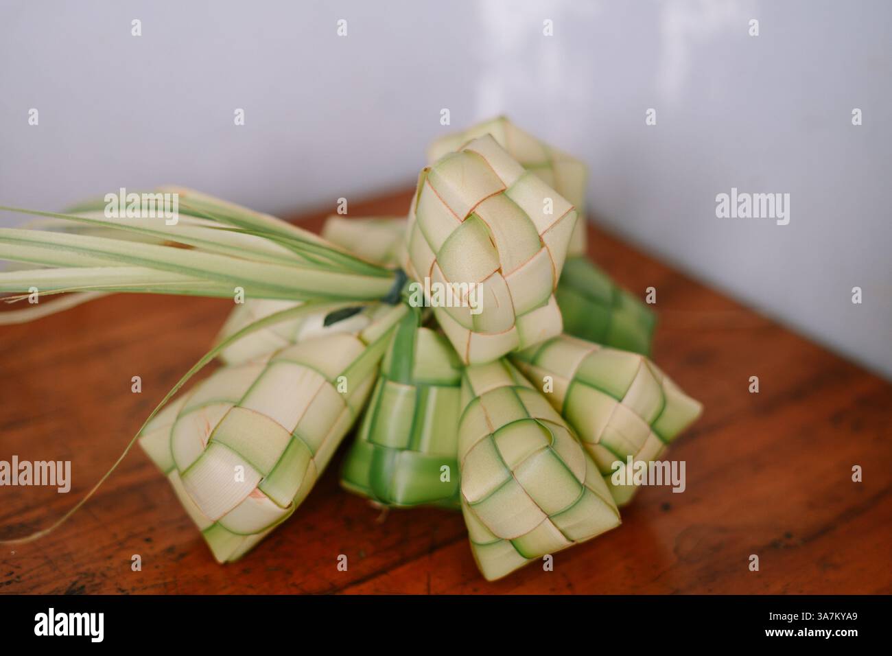 A bunch of ketupat, woven rice dumplings, a popular and traditional ...