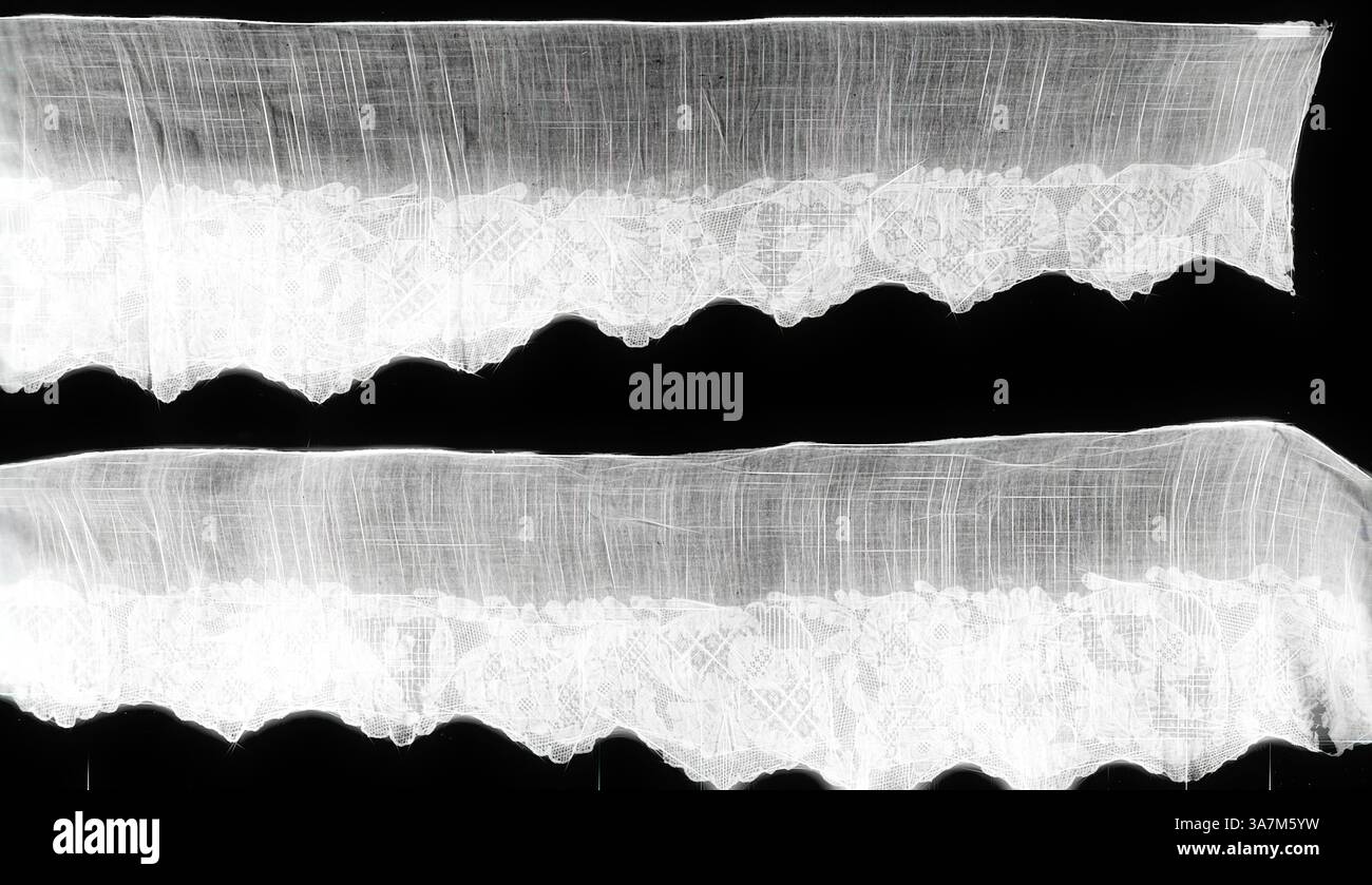 A delicate piece of lace trim featuring intricate patterns and ...