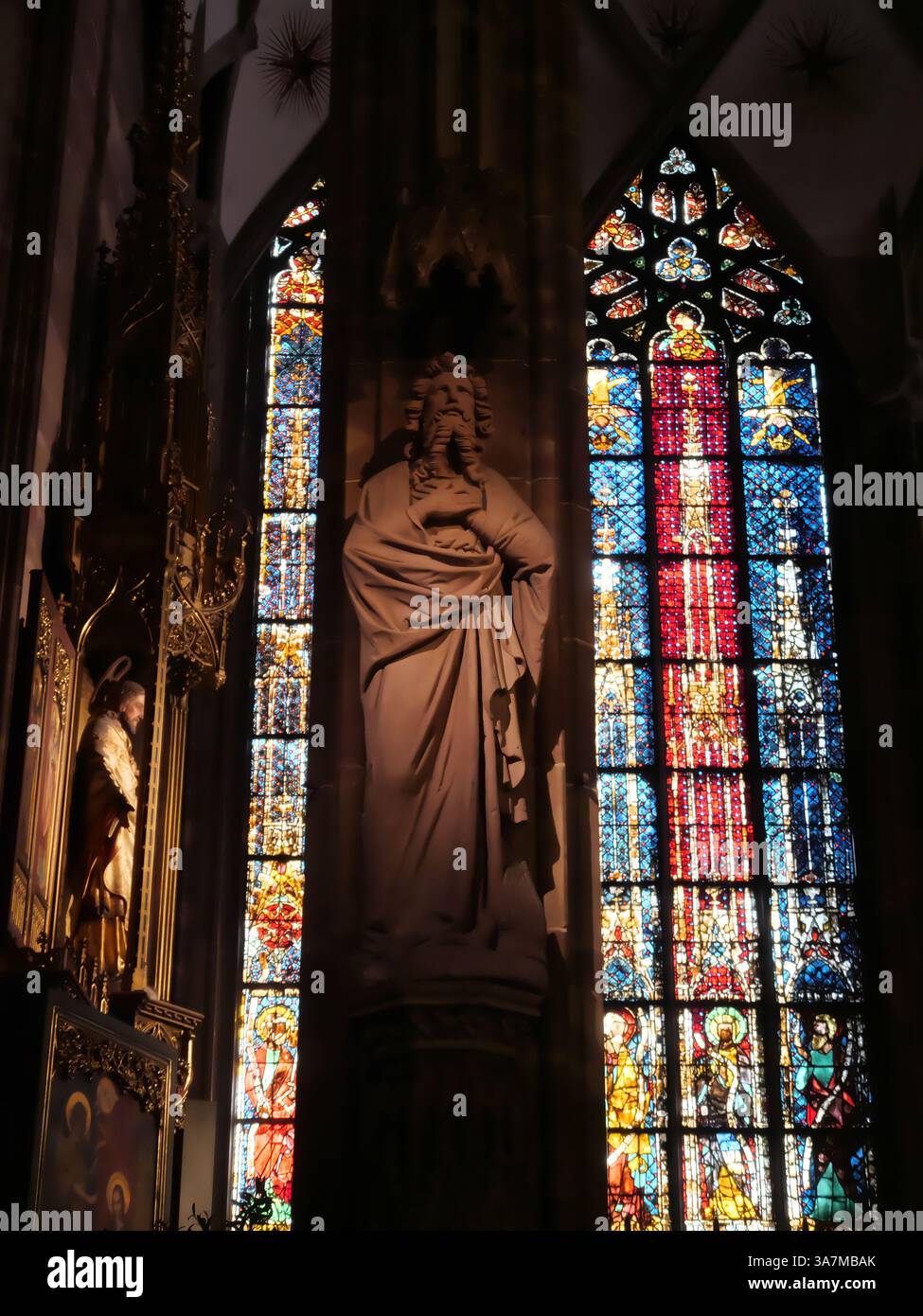 Columns with statues and stained glass windows at Strasbourg Cathedral ...
