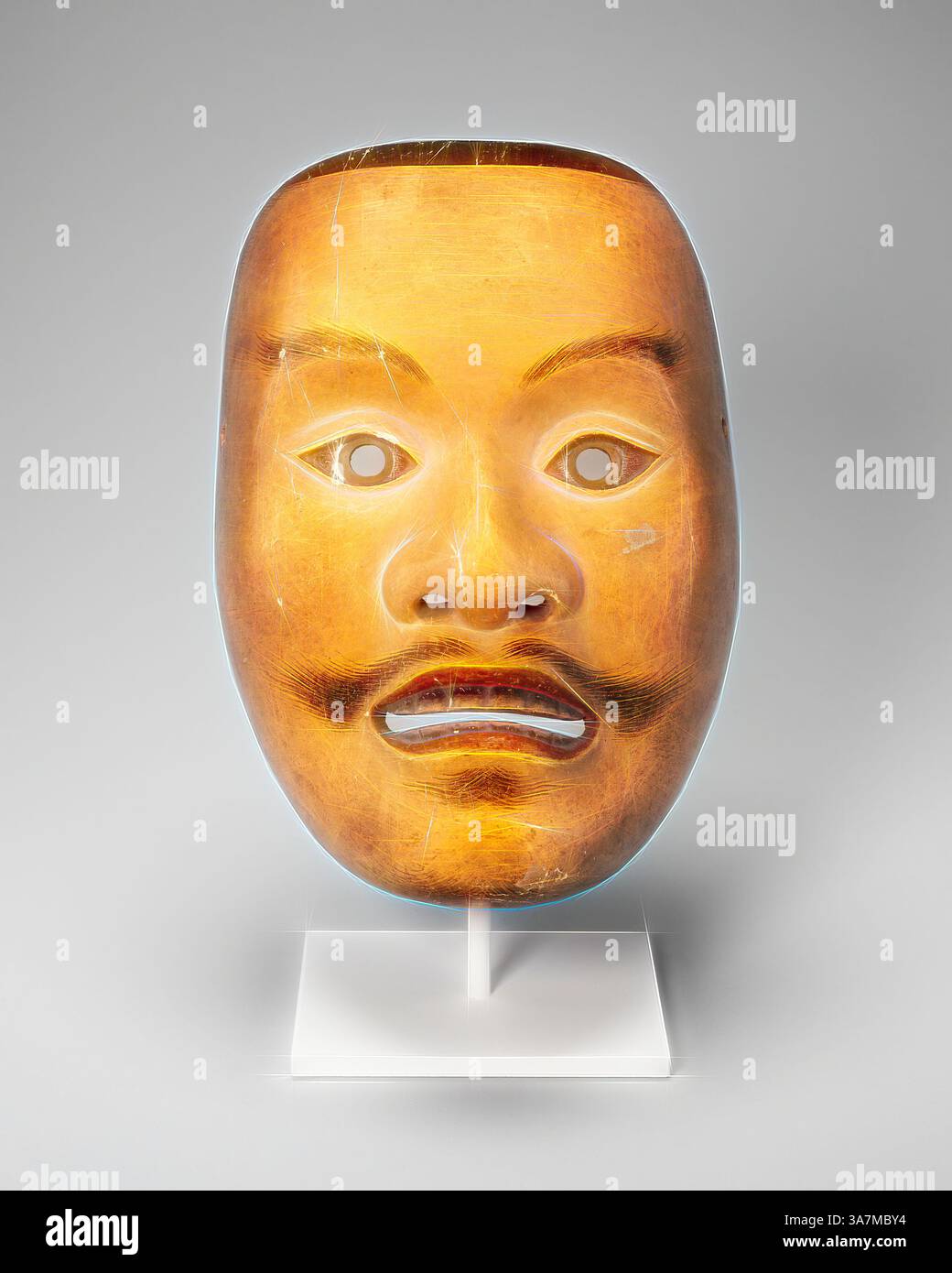 A carved mask with a striking expression, featuring distinct facial ...