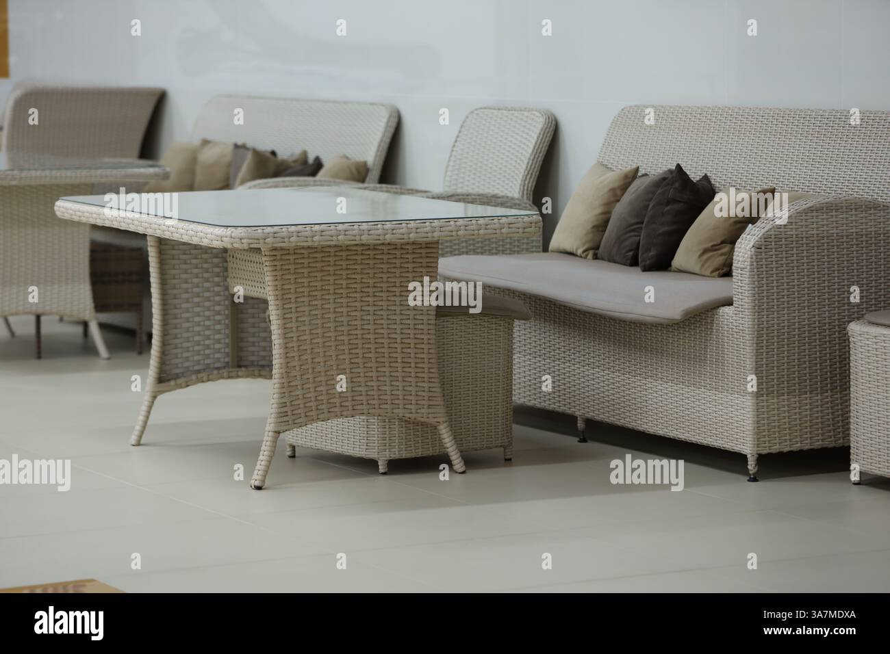Stylish table, poufs and sofas in cafeteria Stock Photo - Alamy