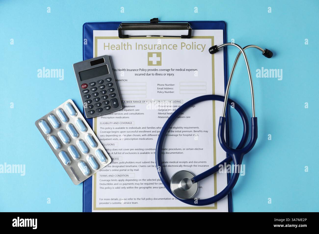Health insurance policy, calculator, pills and stethoscope on turquoise ...