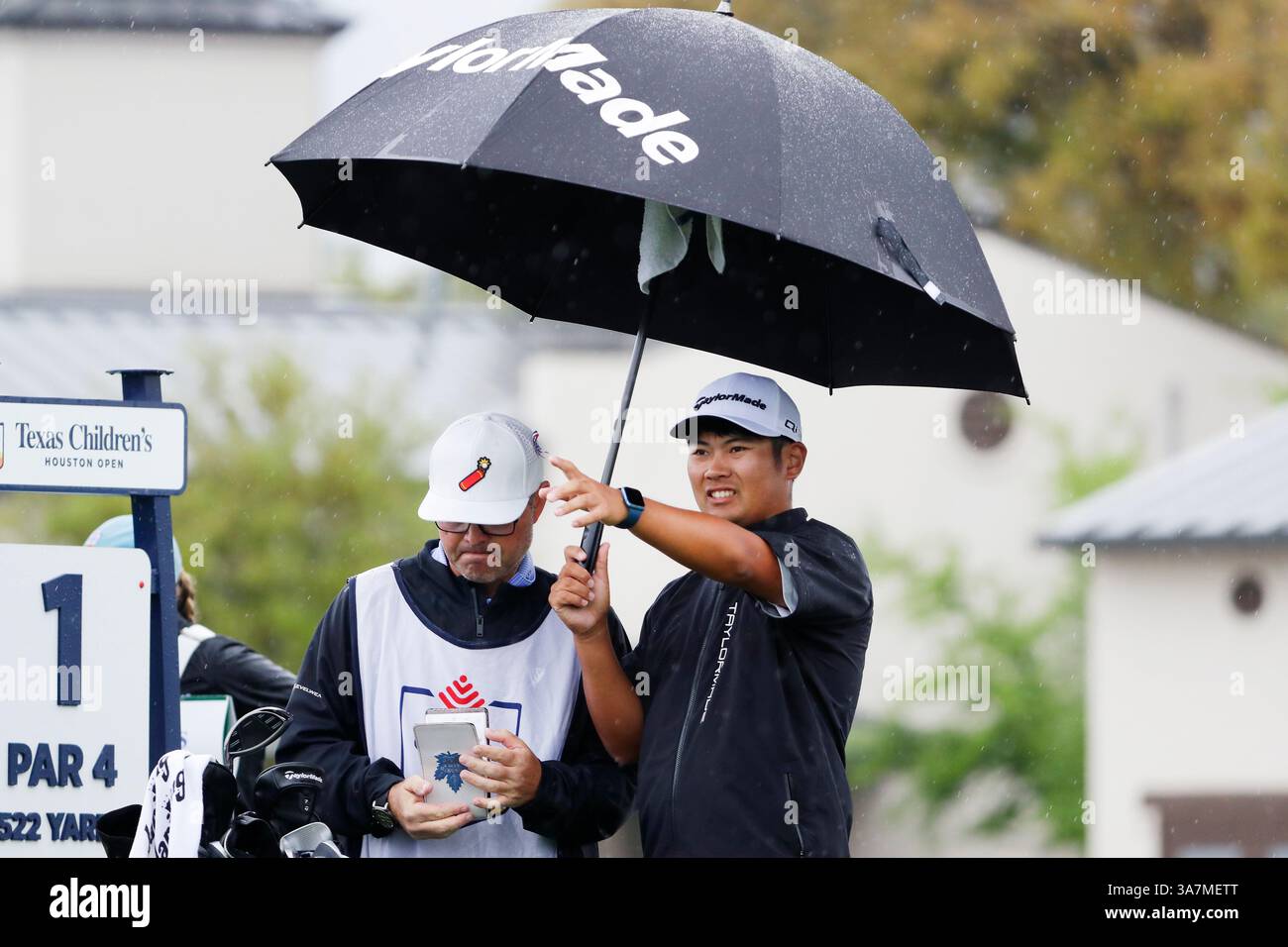 Ryo Hisatsune, right, and his caddie Taiga Tabuchi, left, check the ...
