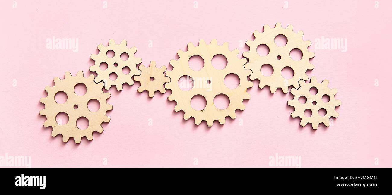 Wooden gears on pink background, top view Stock Photo - Alamy