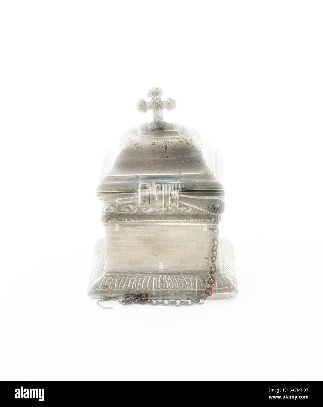 An ornate, silver reliquary adorned with intricate designs and a cross ...