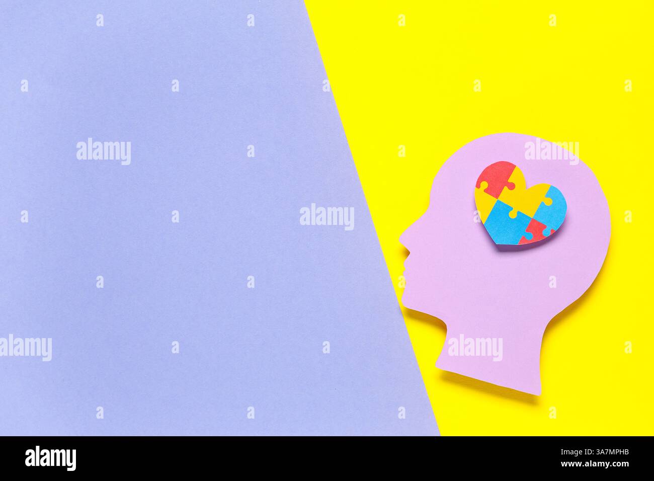 Paper human head with colorful puzzle pieces in shape of heart on color ...