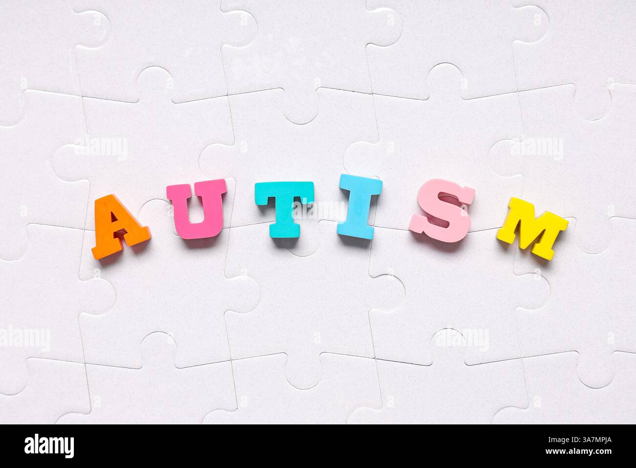 Word AUTISM made of colorful letters on white puzzle pieces Stock Photo ...