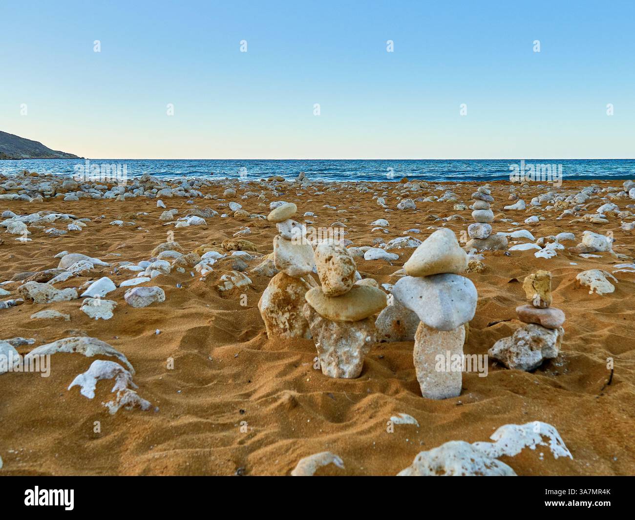 Pile of stones on the beach at Ramla Bay, Malta Stock Photo - Alamy