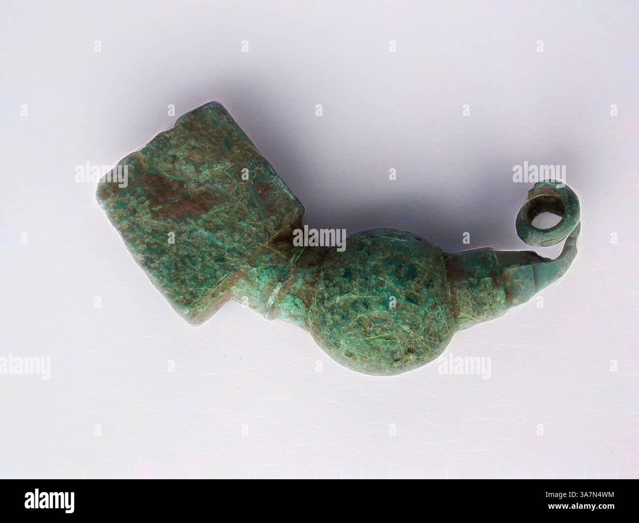 An ancient artifact crafted from greenish metal, featuring a rounded ...