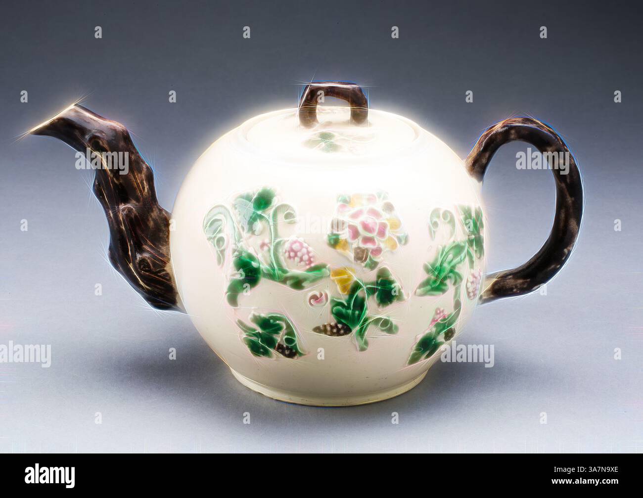An elegantly designed teapot featuring intricate floral patterns and a ...