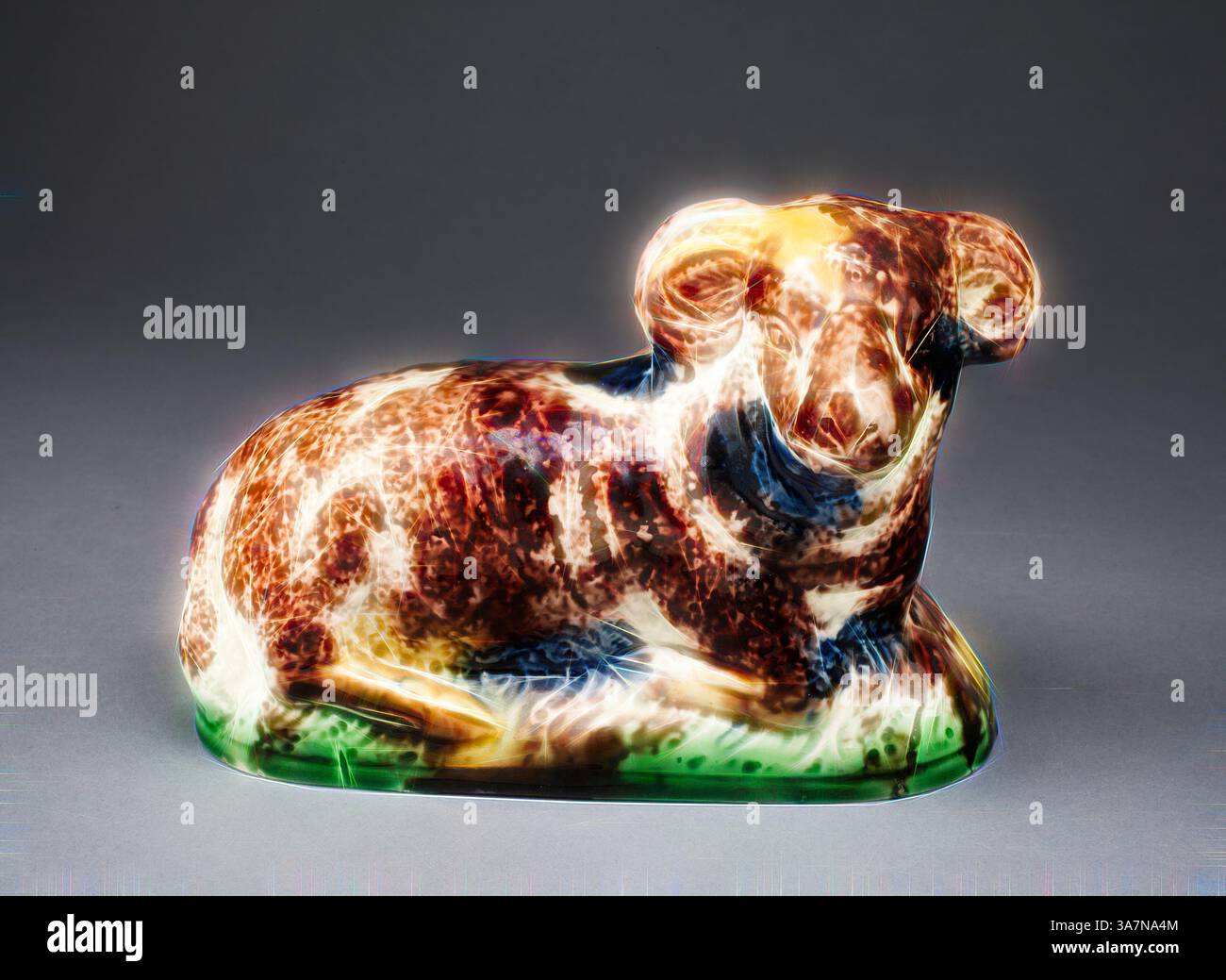A ceramic figurine of a lying ram, showcasing intricate details in its ...