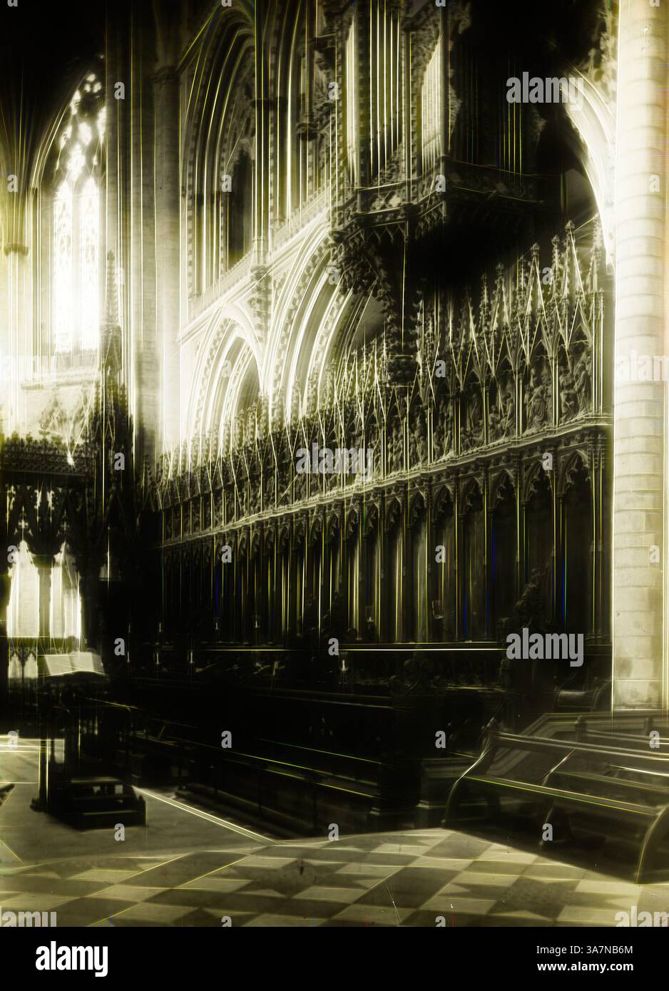 An ornate interior features a row of intricately carved wooden choir ...