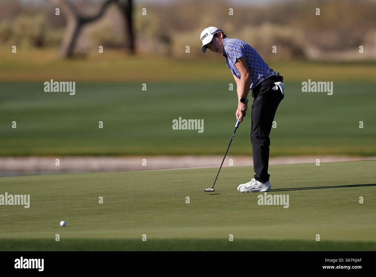 Akie Iwai, of Japan, putts on the 14th green during the first round of ...