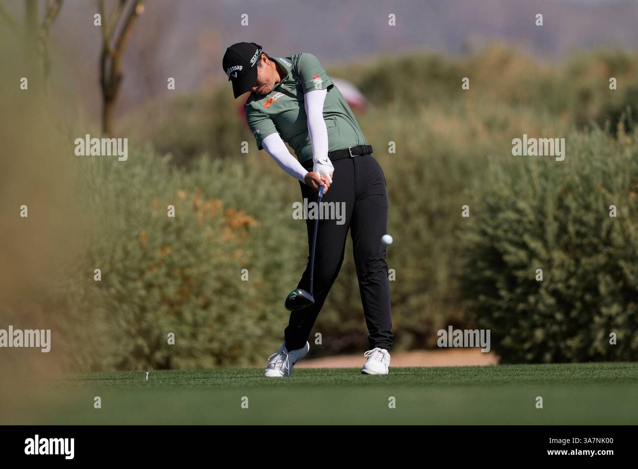 Yuka Saso, of Japan, hits from the 18th tee during the first round of ...