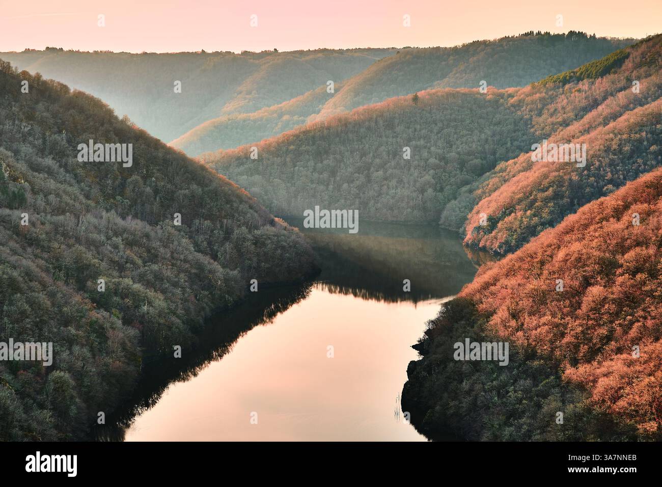 Aerial view of a serene landscape at sunset, featuring rolling hills ...