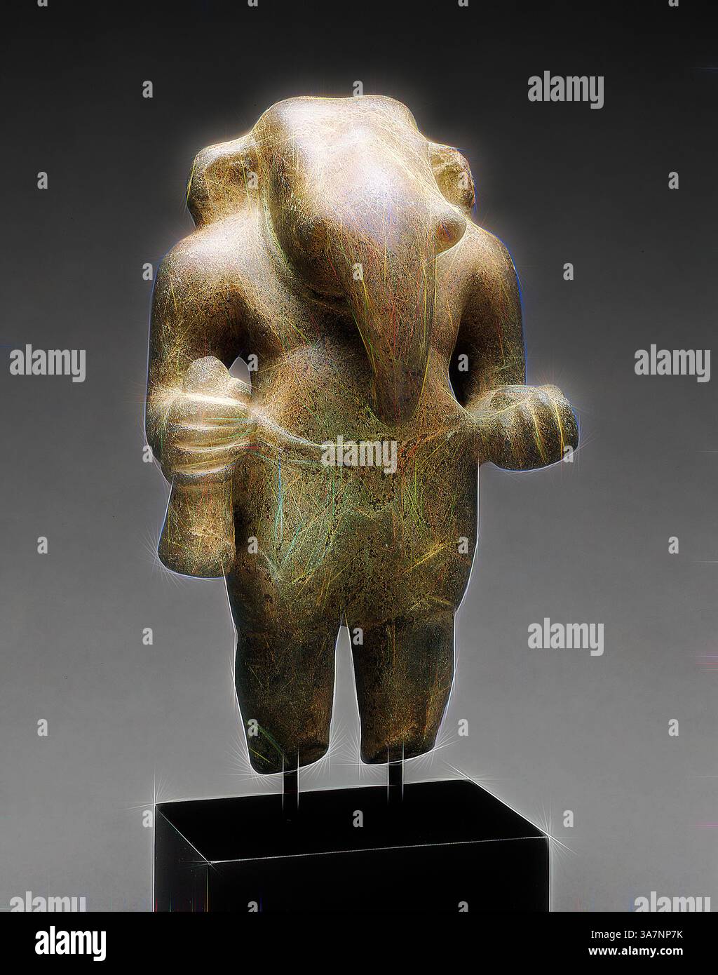 A stylized elephant figure stands upright, holding an object in its ...