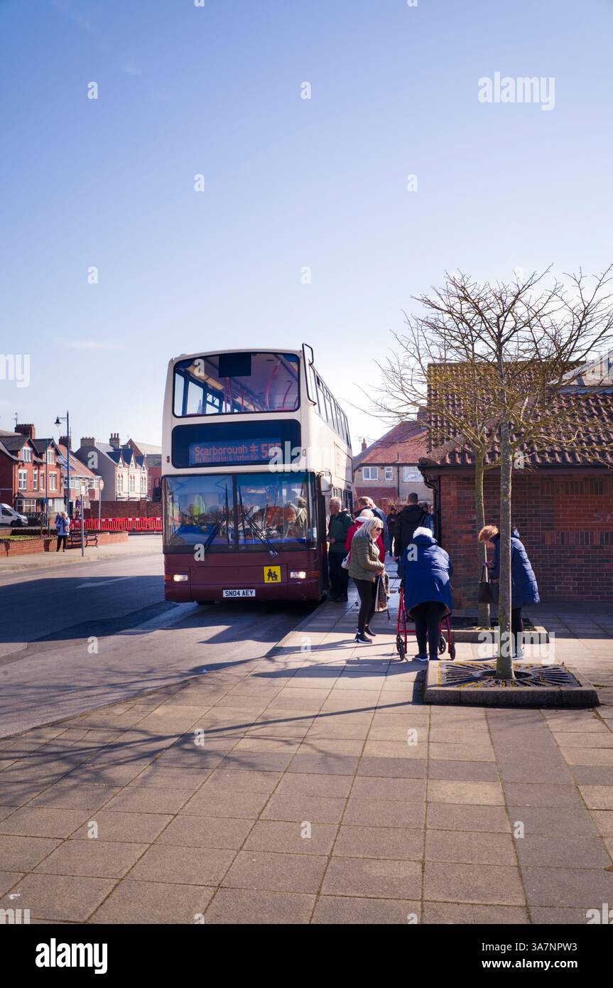 Passengers about to board the 555 bus to Scarborough from Filey bus ...
