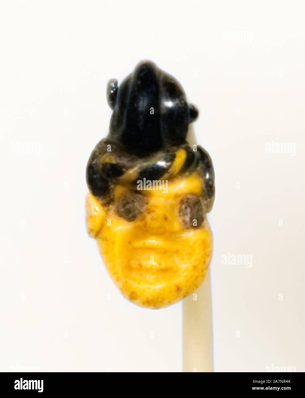 A stylized head sculpture featuring a distinctive hairstyle and facial ...