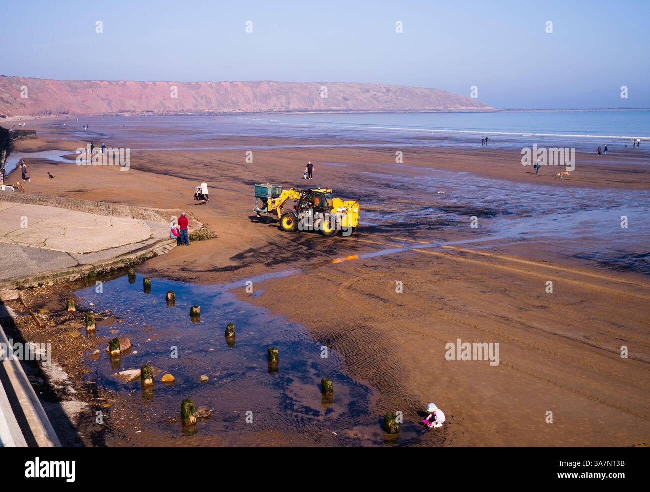 Vehicle on the beach at Filey working on the sea wall repairs Stock ...