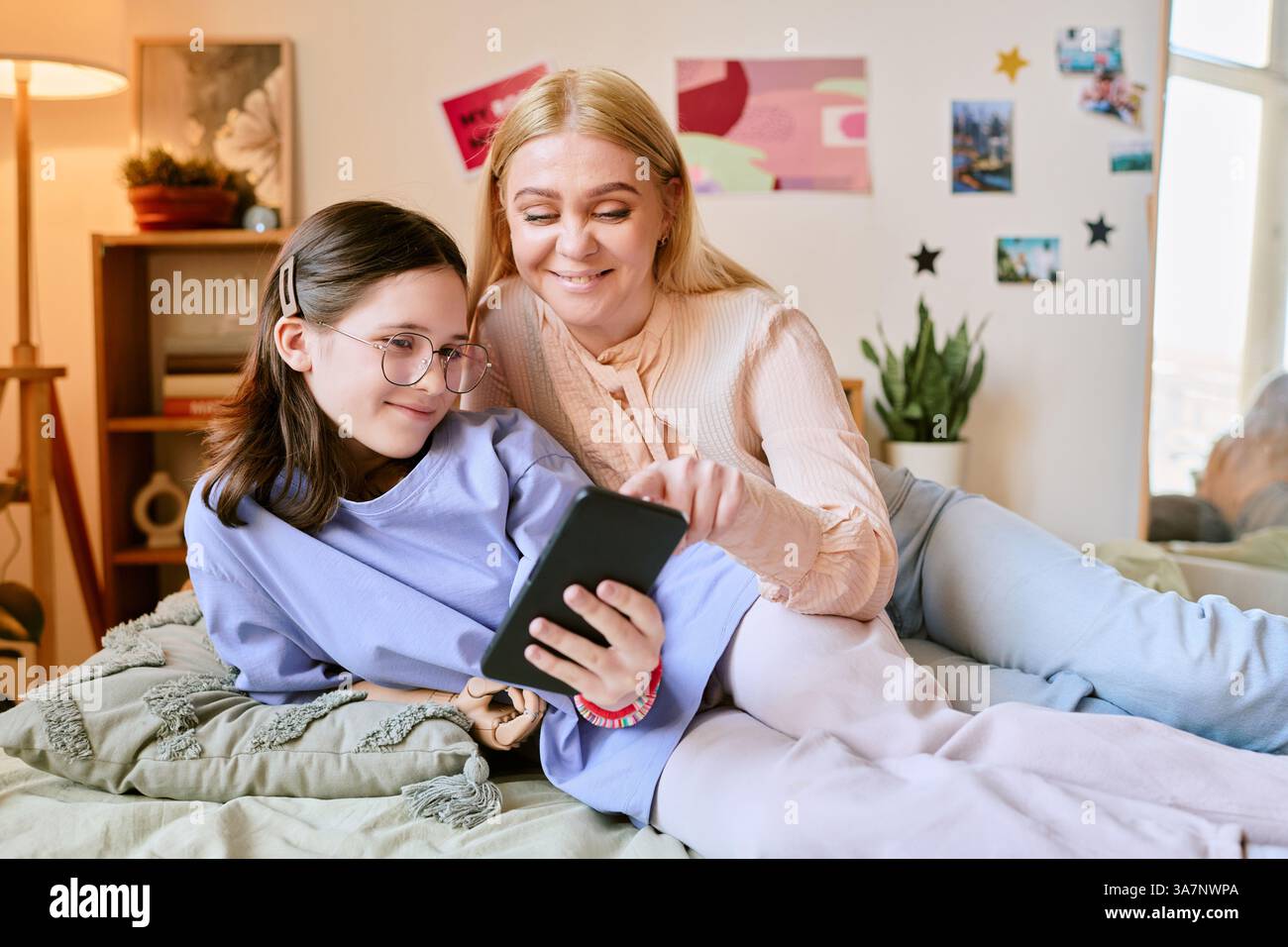 Mother smiling warmly while daughter with prosthetic hand wearing ...