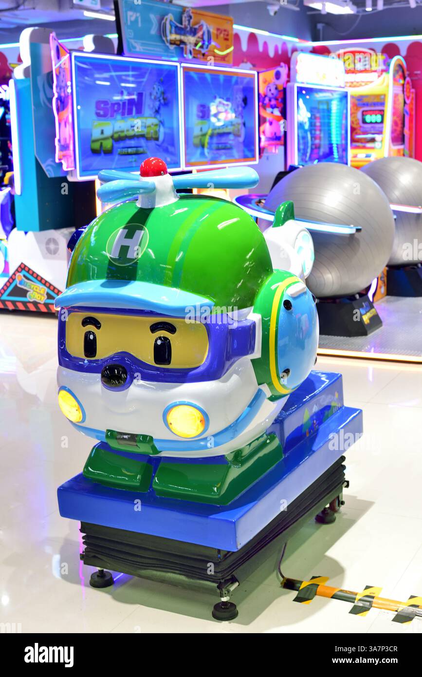 Indoor kiddie ride game machine helicopter in game parlor Stock Photo ...