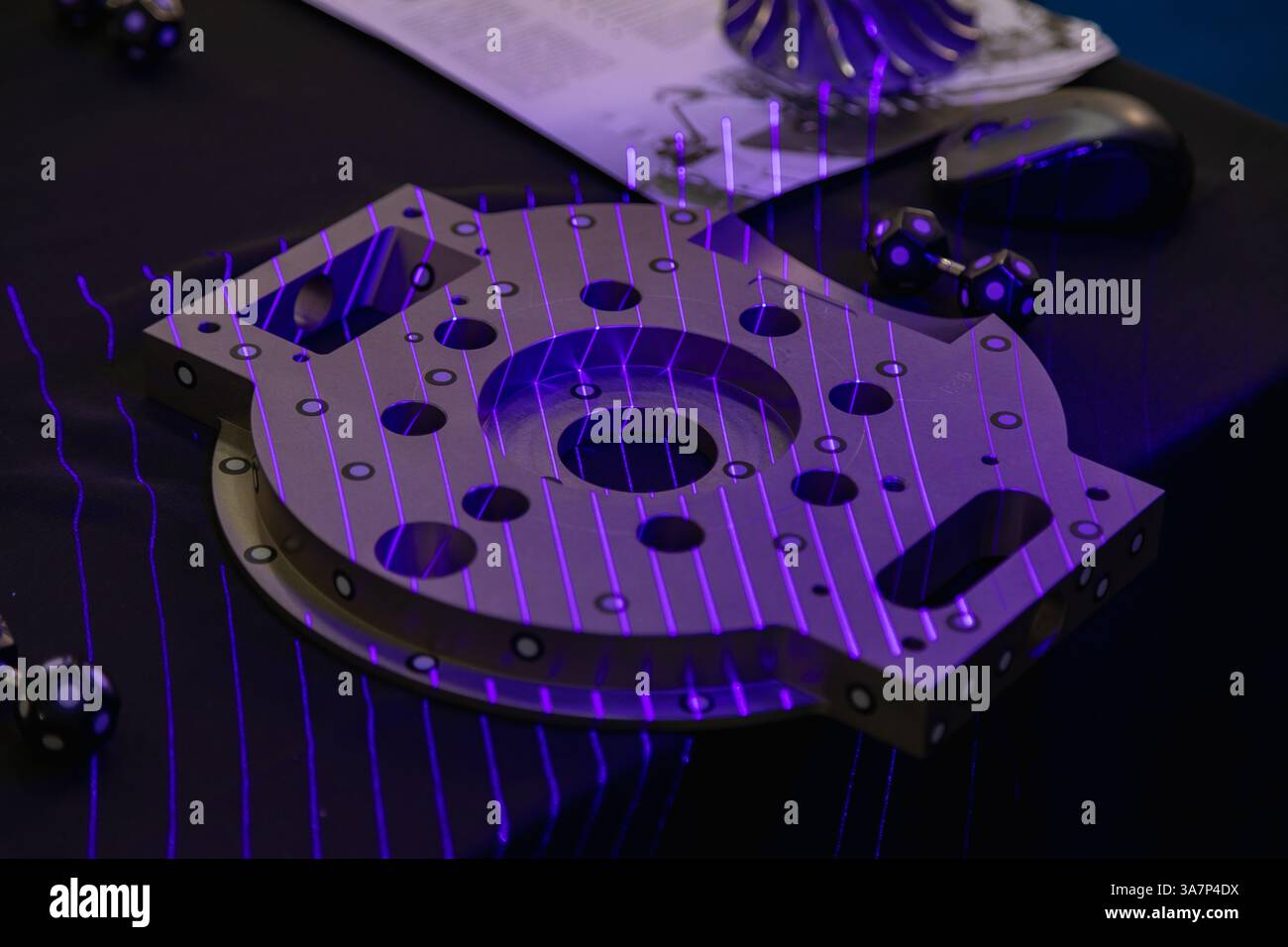 Purple laser lines scanning a mechanical component, enhancing precision in reverse engineering ...