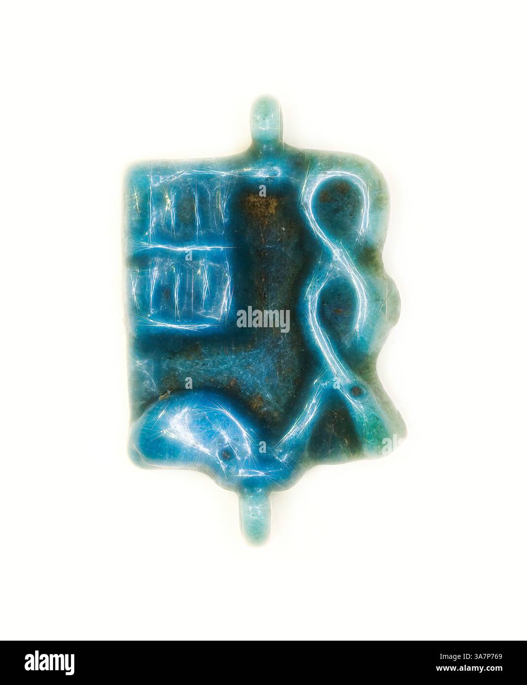 An intricately carved turquoise artifact featuring abstract patterns ...