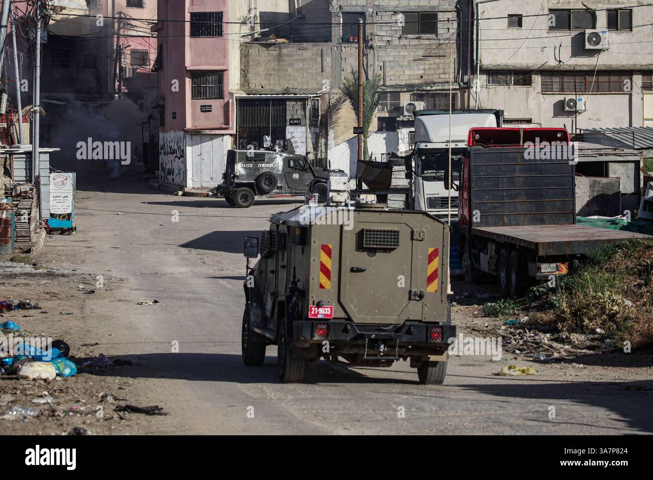 Israeli soldiers arrest several Palestinians during a raid on the Askar ...