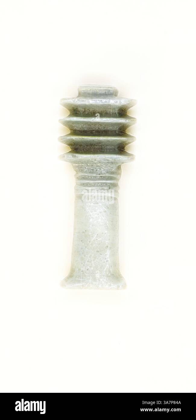 An intricately carved stone artifact with a tall, narrow base and a ...