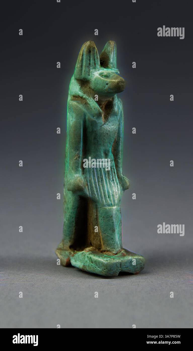 A detailed statuette of a canine-headed deity, adorned with a kilt-like ...