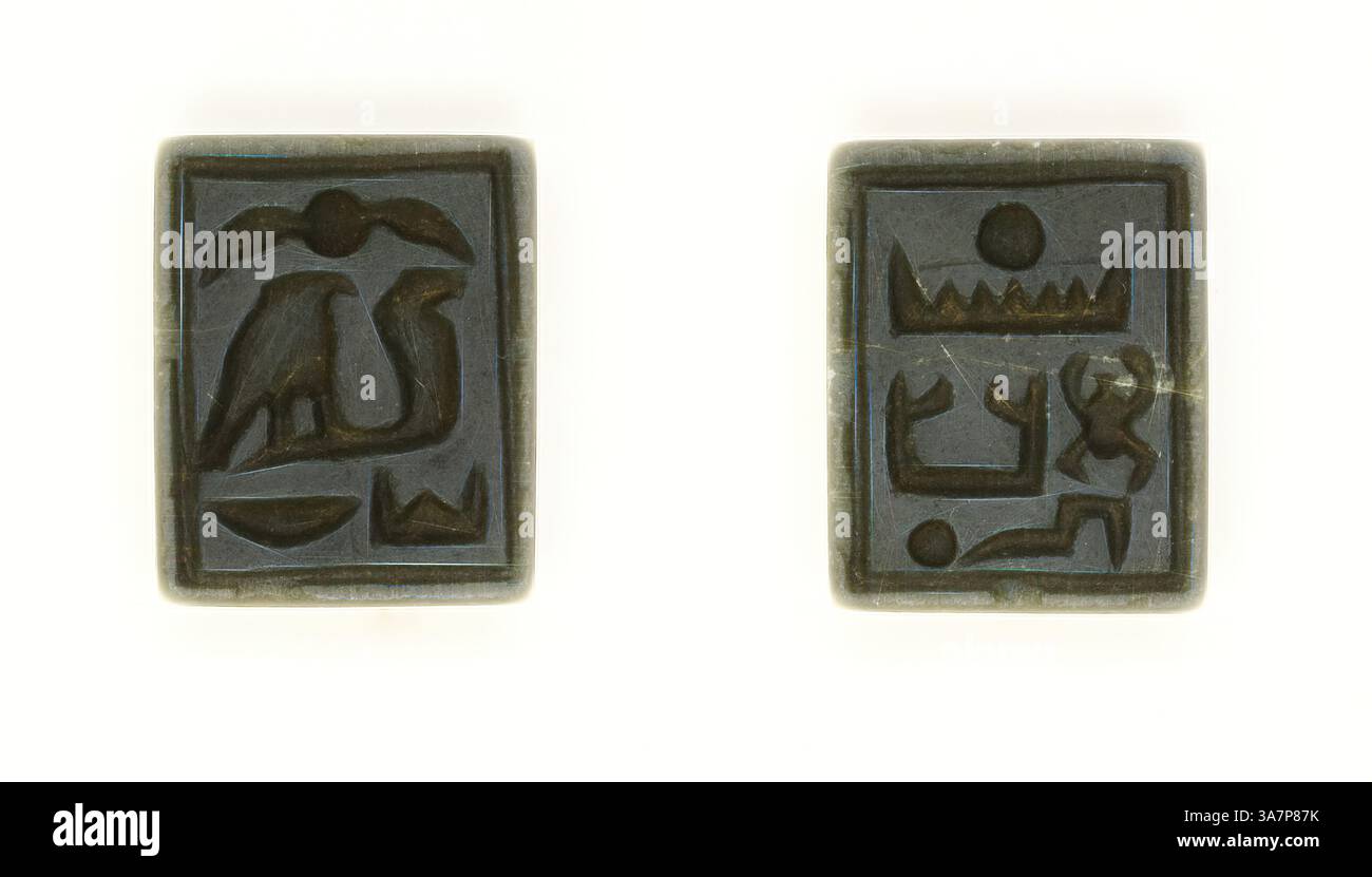 Two carved amulets featuring intricate hieroglyphic designs, showcasing ...