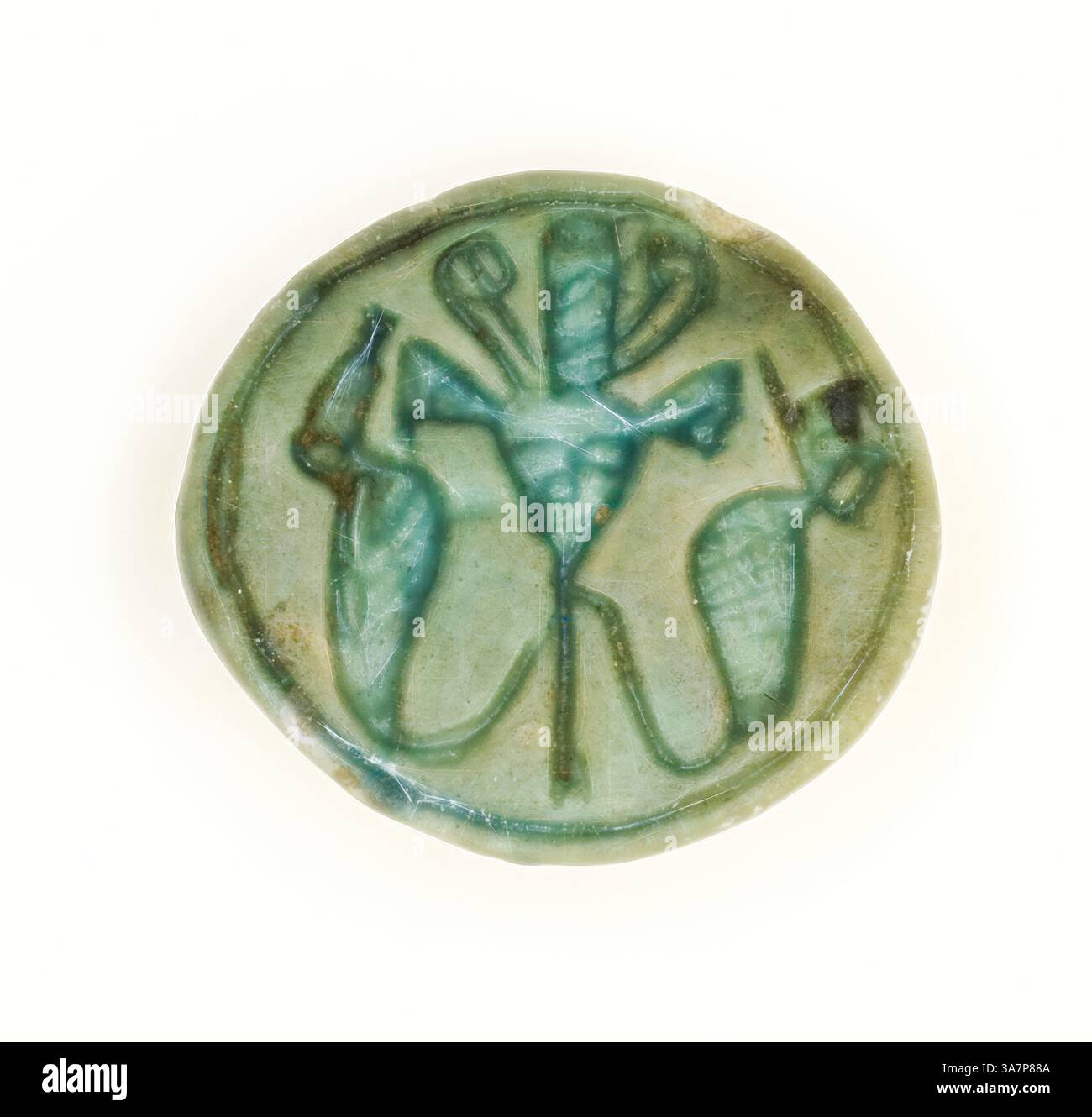 An ancient circular amulet featuring intricate carvings of symbolic ...