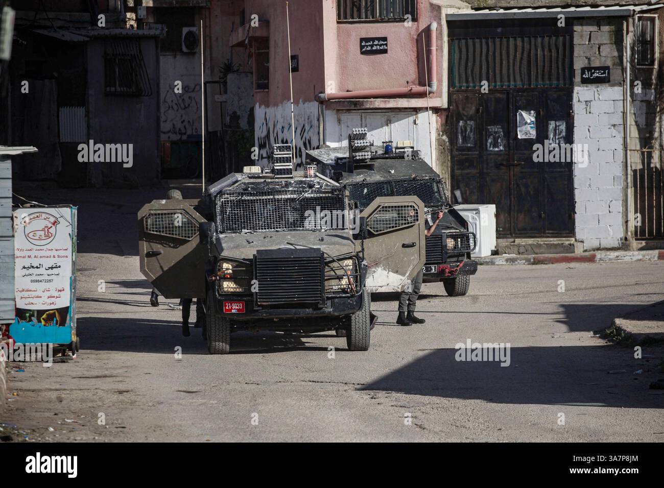 Israeli soldiers arrest several Palestinians during a raid on the Askar ...