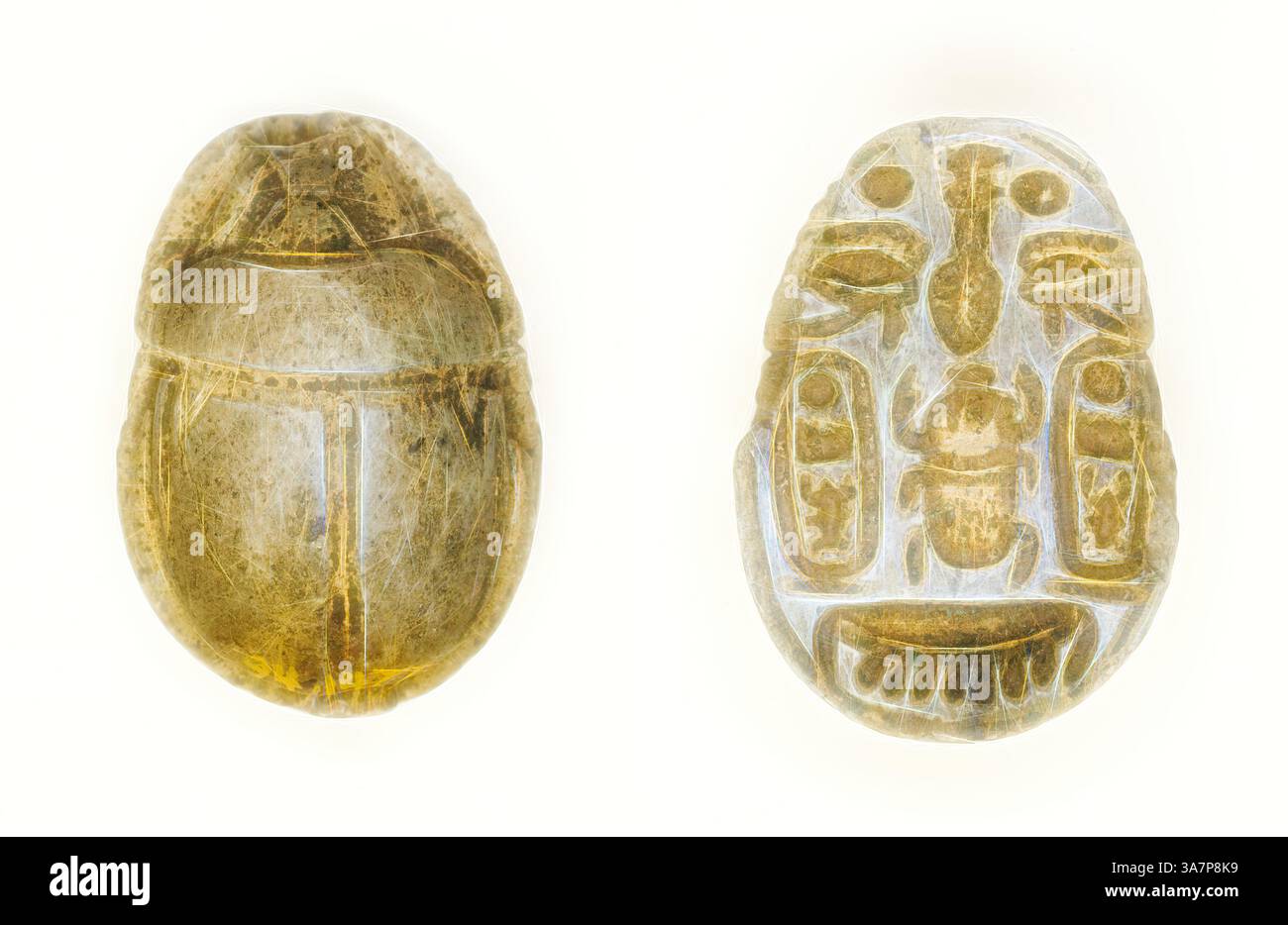 A pair of intricately carved amulets, one depicting a scarab beetle and ...