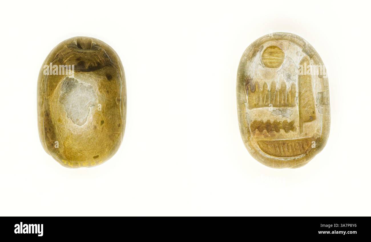 Two ancient Egyptian scarabs, intricately carved with hieroglyphic ...