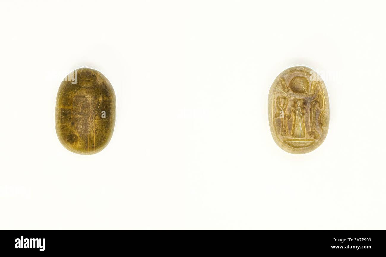 Two ancient scarab amulets, each intricately carved with detailed ...