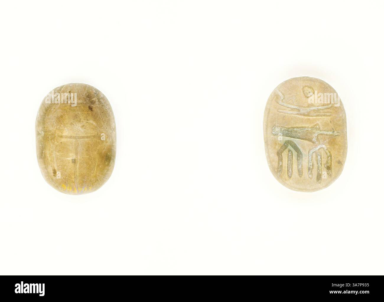 Two oval-shaped stones are displayed side by side, each engraved with ...