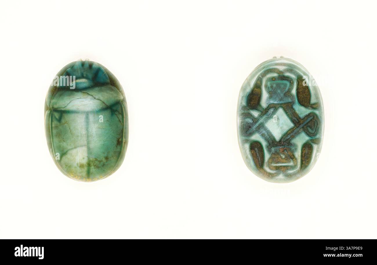 Two intricately designed scarab amulets, one featuring a smooth ...