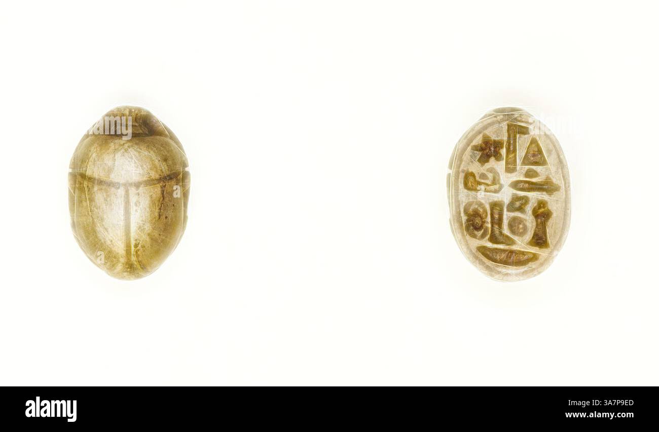 Two intricately carved scarab amulets, one smooth and rounded, the ...